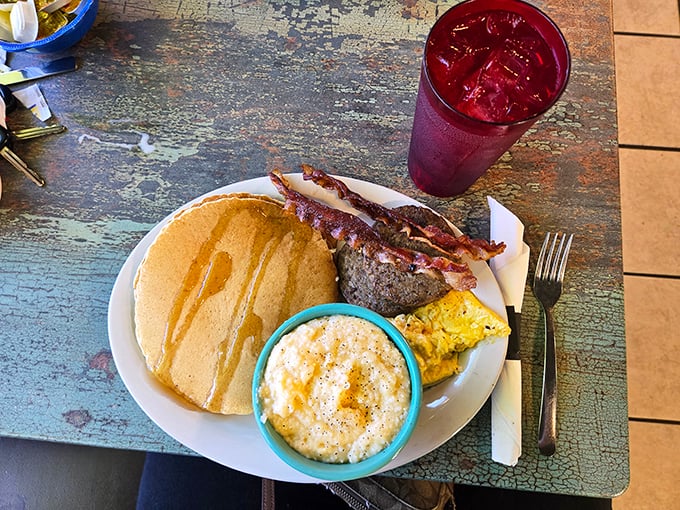 Breakfast nirvana: golden pancakes, perfectly cooked meat, and grits that would make any Southerner nod in approval. The red drink is just showing off.