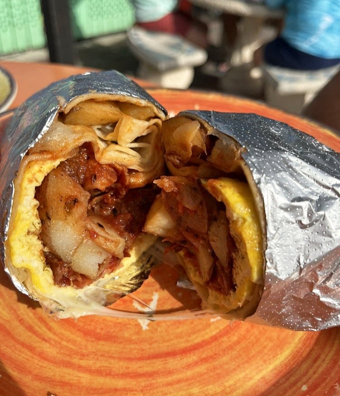 Behold the infamous breakfast burrito—a foil-wrapped package of morning bliss that delivers on every promise the menu makes.