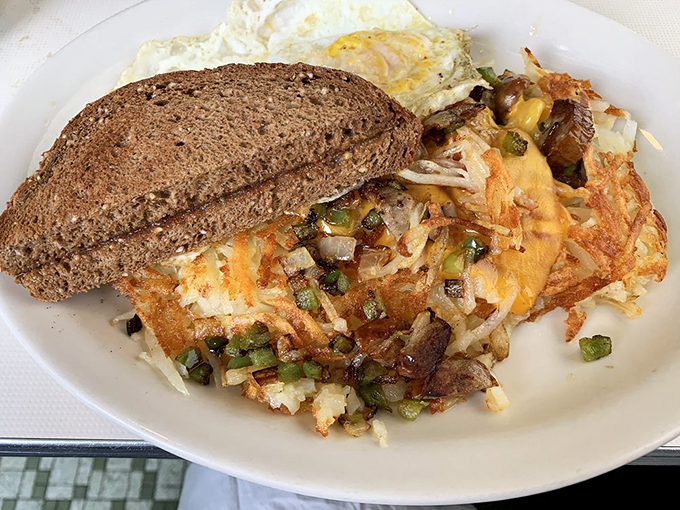 This isn't just breakfast—it's edible architecture. Crispy hash browns form the foundation while eggs and toast complete this masterpiece of morning engineering.