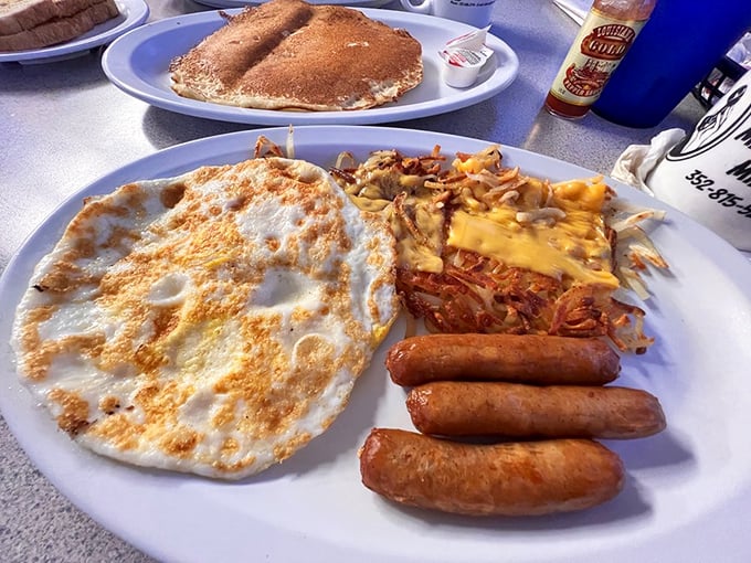 Breakfast perfection doesn't need to be complicated—just eggs cooked exactly right, sausage links with snap, and hash browns that mean business.