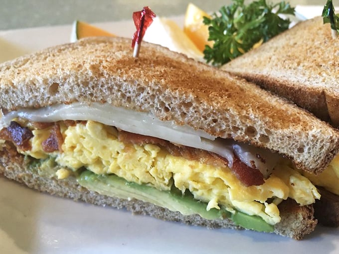 This isn't just a breakfast sandwich—it's a masterclass in morning architecture with perfectly scrambled eggs, bacon, and avocado between toasty bread.