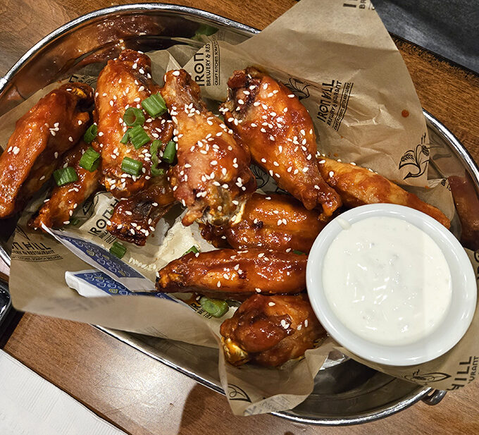 Wing perfection isn't just about sauce—it's a science. These glistening beauties with their sesame seed garnish might just ruin all other wings for you forever.