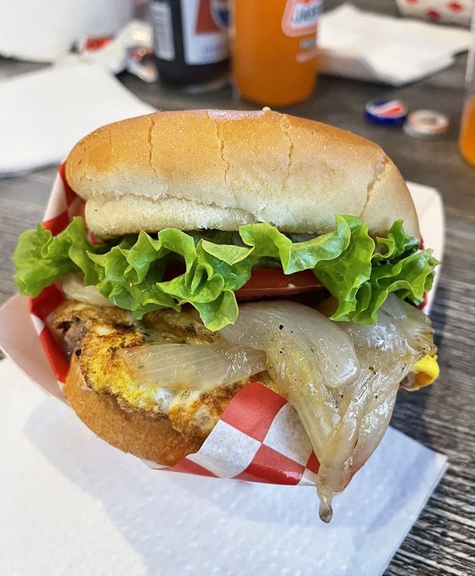 This burger isn't playing hard to get—melty cheese cascading over the patty like it's auditioning for a food commercial.
