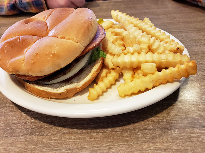 The burger arrives like an old friend who's never let you down—unpretentious, reliable, and exactly what you needed without knowing you needed it.