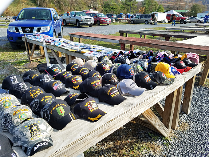 Military pride on display! Veteran-themed caps line wooden tables, each representing service, sacrifice, and stories that deserve more than just passing glances.