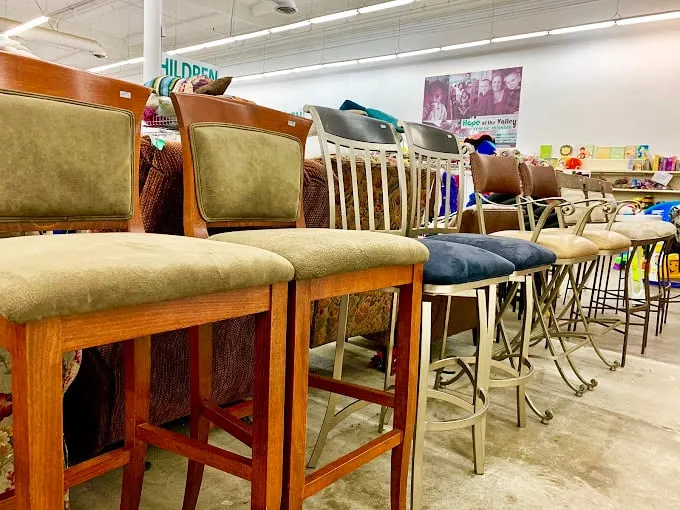Bar stools lined up like eager contestants on a game show, each one hoping to be the perfect perch for your kitchen counter.