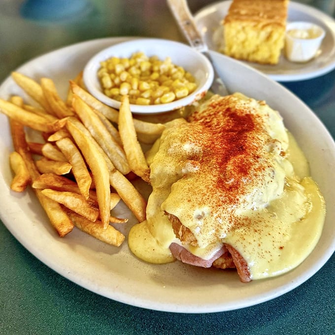 Eggs Benedict doesn't wear a disguise here—it shows up in all its golden-sauced glory, with crispy fries standing guard.