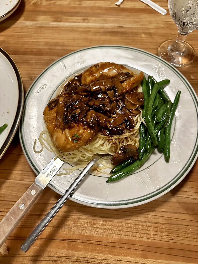 This chicken dish isn't just dinner—it's a symphony of savory mushrooms and tender protein performing on a bed of angel hair.