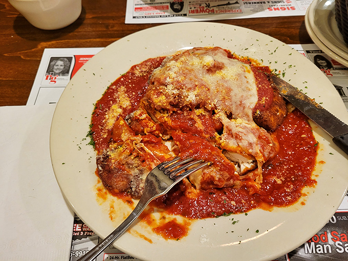 This chicken parmigiana isn't just dinner—it's edible architecture: layers of crispy breading, tender chicken, and molten cheese swimming in a sea of vibrant marinara.