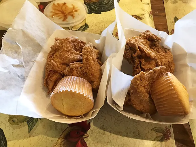 Golden-brown chicken perfection nestled in paper baskets alongside cornbread muffins—proof that simplicity, when executed flawlessly, creates the most profound food memories.