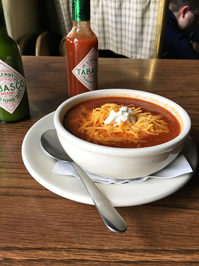 This isn't just chili—it's a warm hug in a bowl. Topped with melted cheese and a dollop of sour cream, it's the comfort food equivalent of finding money in an old jacket.