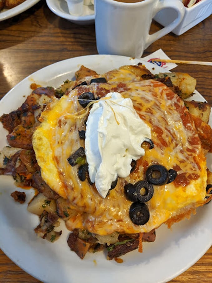 This isn't just breakfast—it's an architectural masterpiece of potatoes, eggs, cheese, and olives that would make Frank Lloyd Wright jealous.