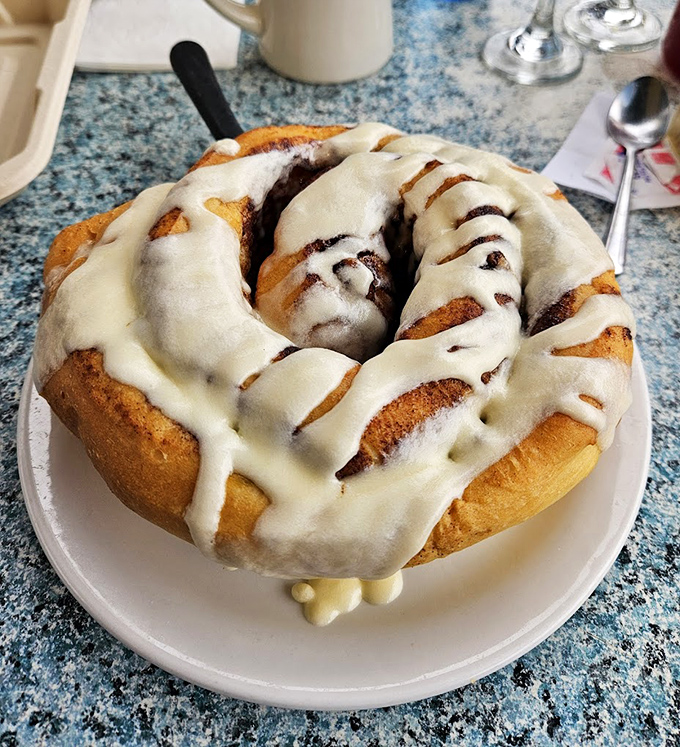 Not so much a cinnamon roll as a cinnamon continent, this glazed masterpiece has its own gravitational pull and should come with a warning label.