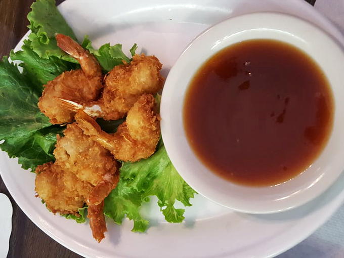 Golden coconut armor protects sweet shrimp treasures, each bite a tropical vacation for your taste buds.
