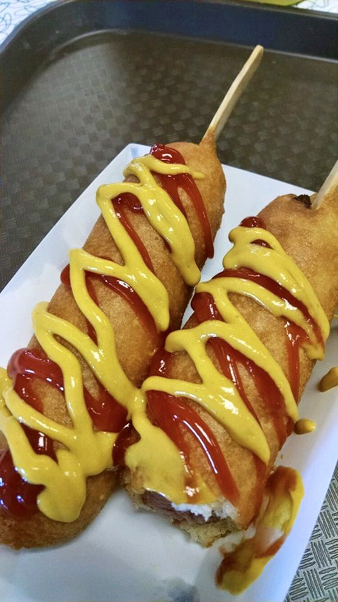 These golden-battered beauties aren't just corn dogs – they're edible time machines, transporting you back to when food on a stick was revolutionary.