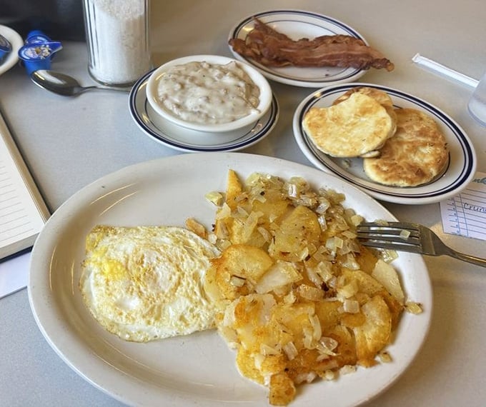 Breakfast nirvana exists, and it looks exactly like this. Fluffy biscuits with a side of rich gravy, golden home fries, and perfectly cooked eggs that whisper, ‘Come to me.’