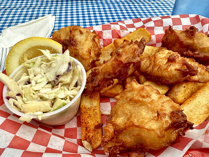 Golden-battered fish that shatters with each bite, nestled alongside hand-cut fries. The coleslaw provides the perfect tangy counterpoint.