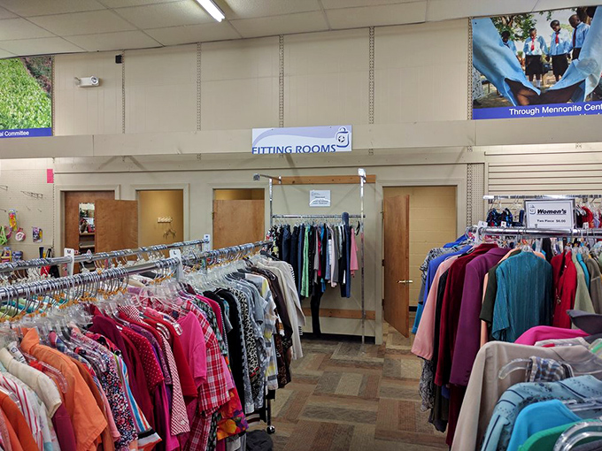 The fitting room area—that sacred space where thrift store optimism meets reality. "Please fit, please fit" is the silent prayer of bargain hunters everywhere.