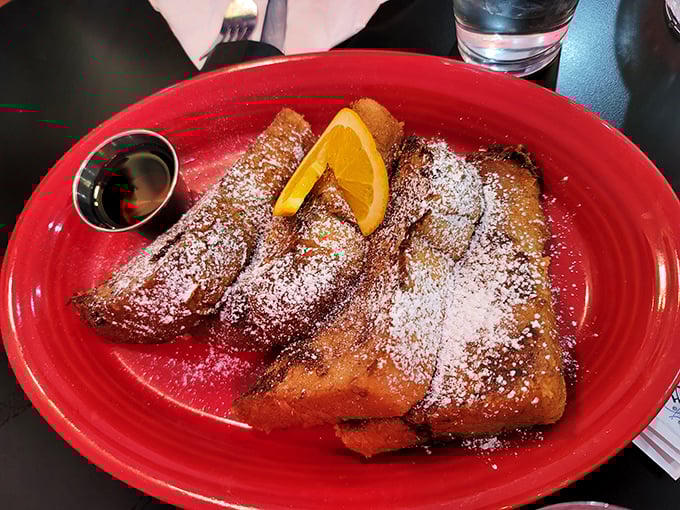 The French toast that launched a thousand return visits. Golden-brown perfection dusted with powdered sugar – breakfast alchemy at its finest.