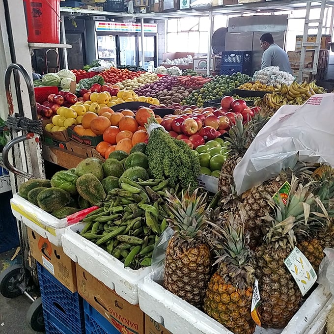 Nature's candy store! Pineapples, avocados, and mangoes stacked with military precision—the produce section Michelangelo would have painted.