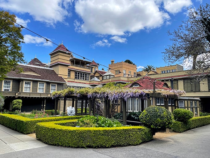 The meticulously maintained gardens provide a deceptively normal counterpoint to the architectural chaos that awaits within.