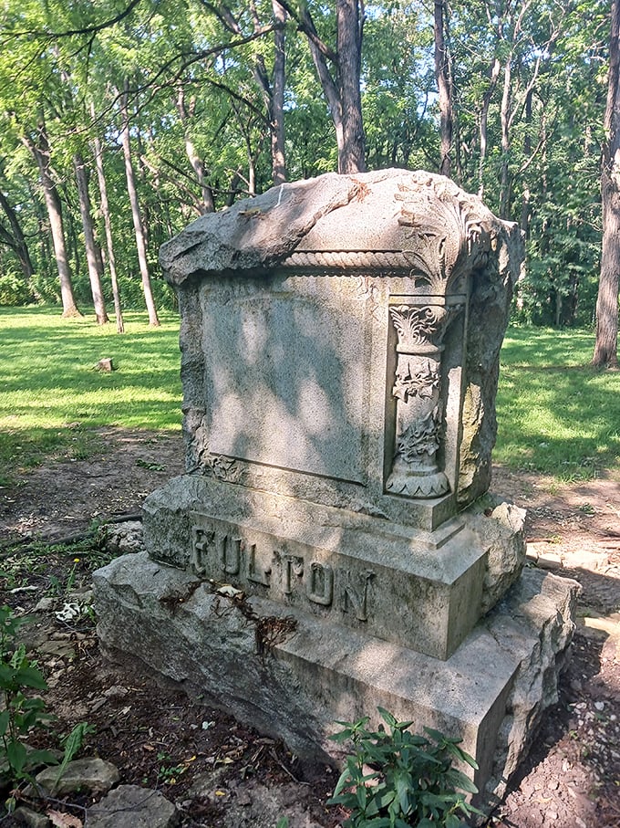 The Fulton monument in daylight reveals intricate carvings and craftsmanship that has withstood decades of Illinois seasons.