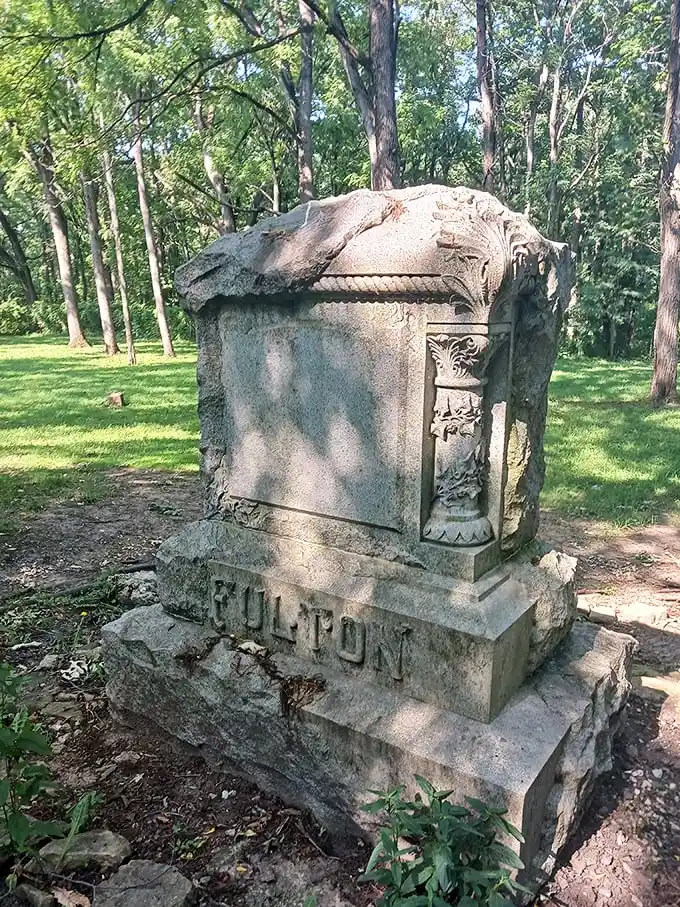 The Fulton monument in daylight reveals intricate carvings and craftsmanship that has withstood decades of Illinois seasons.
