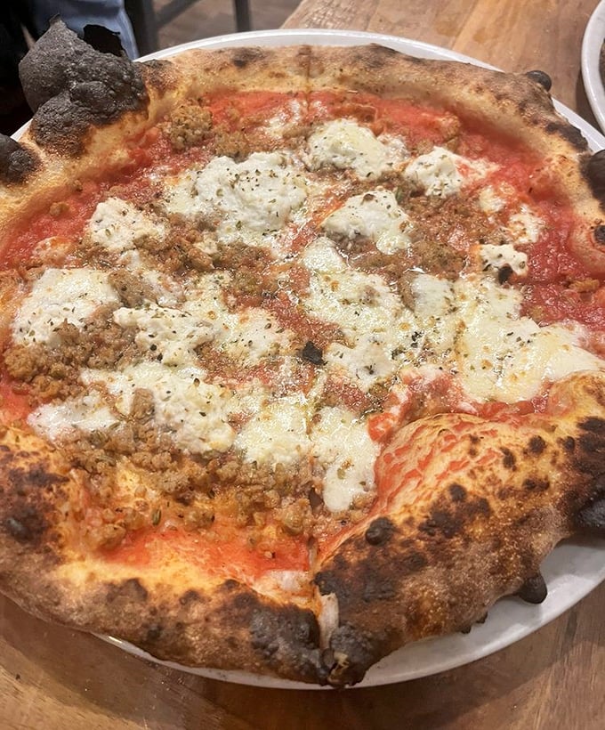 This isn't just pizza—it's a masterpiece of bubbling cheese, savory toppings, and that perfectly charred Neapolitan crust that dreams are made of.
