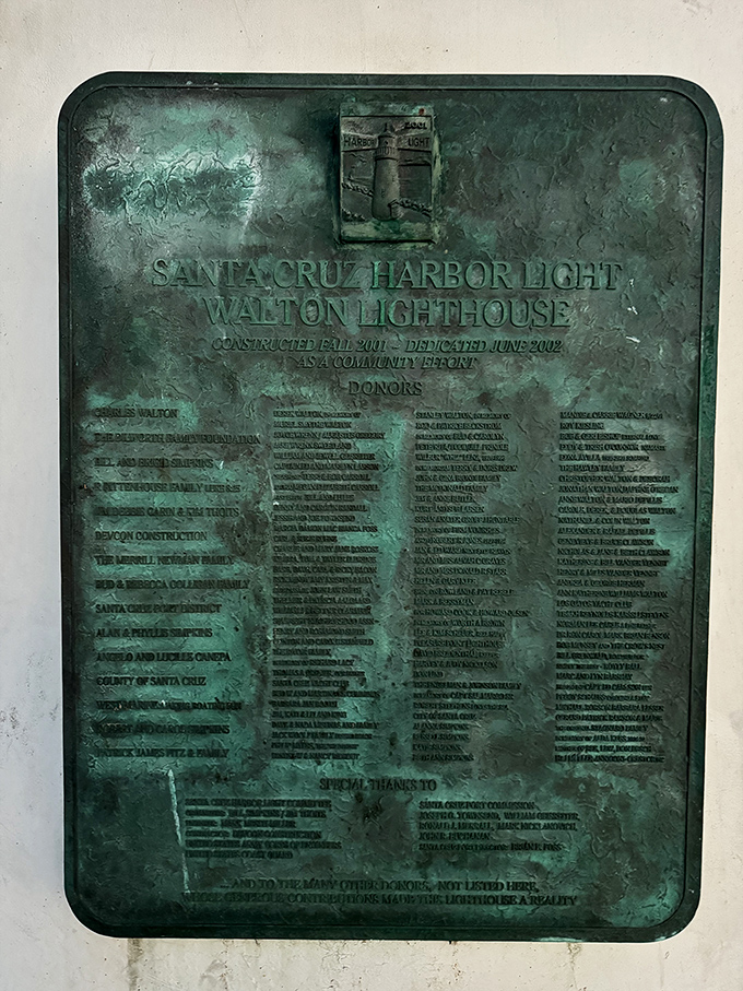 History cast in bronze—the dedication plaque tells the lighthouse's story while the patina speaks of salty air and countless sunsets. Some reading material that won't ask for your Wi-Fi password.