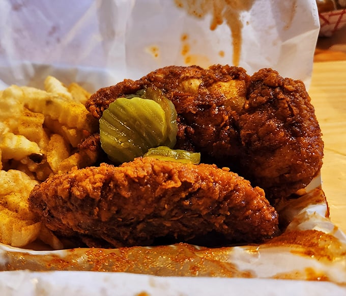 Glistening with that signature red spice oil, this chicken doesn't just look hot—it's practically radiating warning signals like nature's most dangerous creatures.