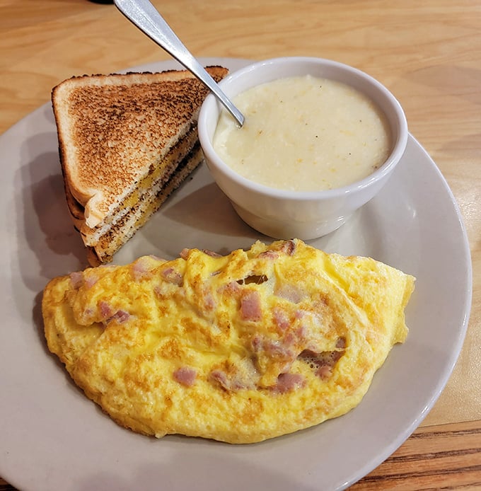 This isn't just an omelet – it's a fluffy golden pillow of breakfast perfection, paired with toast and soup that complete the comfort trifecta.