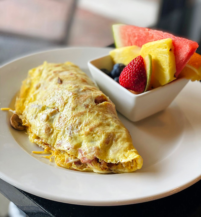 Golden perfection folded around a treasure of fillings. This omelet doesn't just satisfy hunger—it resolves existential breakfast crises.