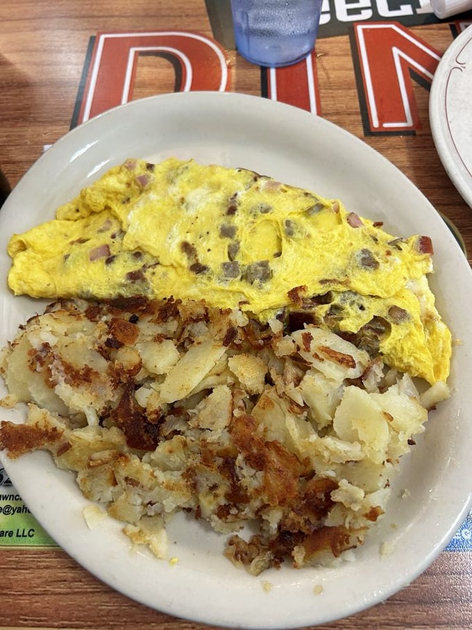 The Western omelet that launched a thousand road trips—perfectly folded sunshine alongside home fries that deserve their own fan club.