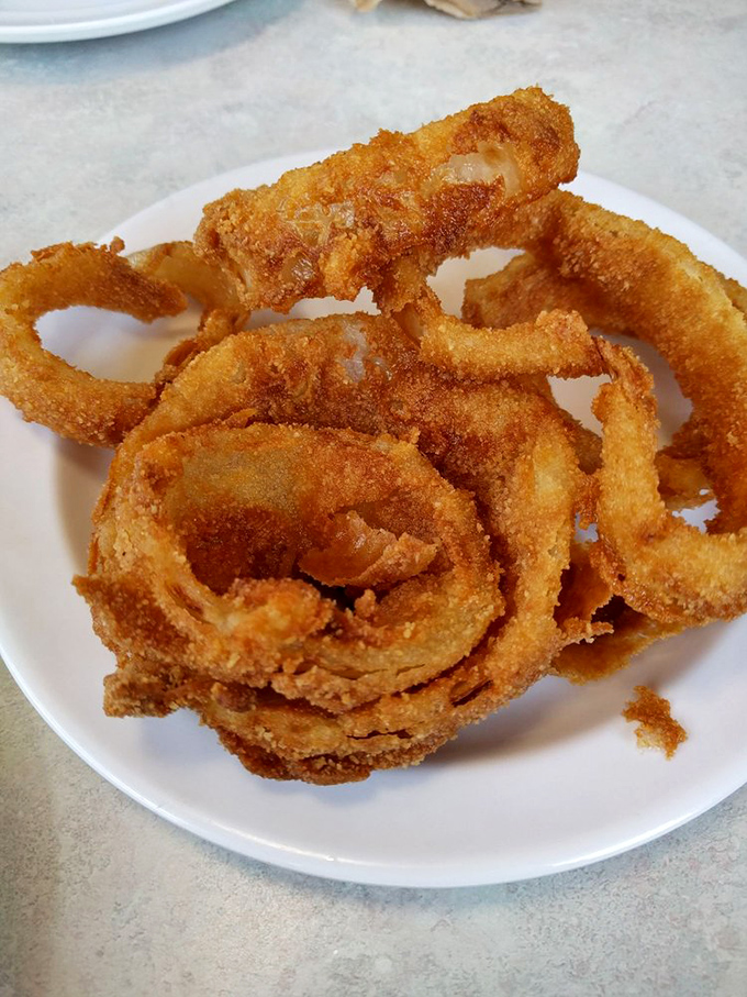 Golden halos of crispy perfection. These aren't just onion rings—they're edible time machines transporting you back to when food was simple, honest, and utterly irresistible.