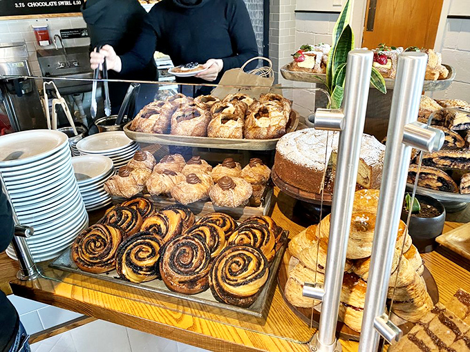 Cinnamon rolls lined up like edible works of art—proof that sometimes the most beautiful galleries are behind glass cases.