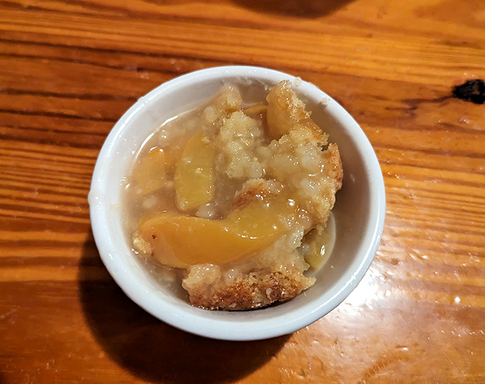 The legendary peach cobbler in all its glory—where South Carolina peaches meet buttery crust in a relationship more perfect than any Hollywood romance.
