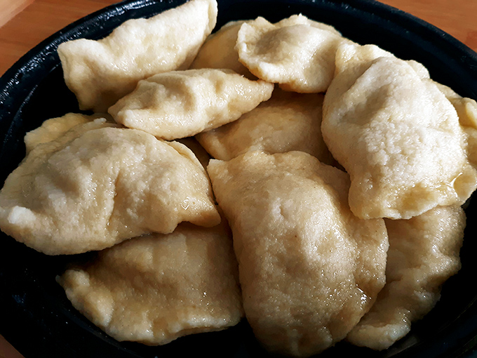 Pillowy pockets of perfection! These golden-brown pierogies aren't just food—they're edible time machines transporting you straight to a Polish grandmother's kitchen.
