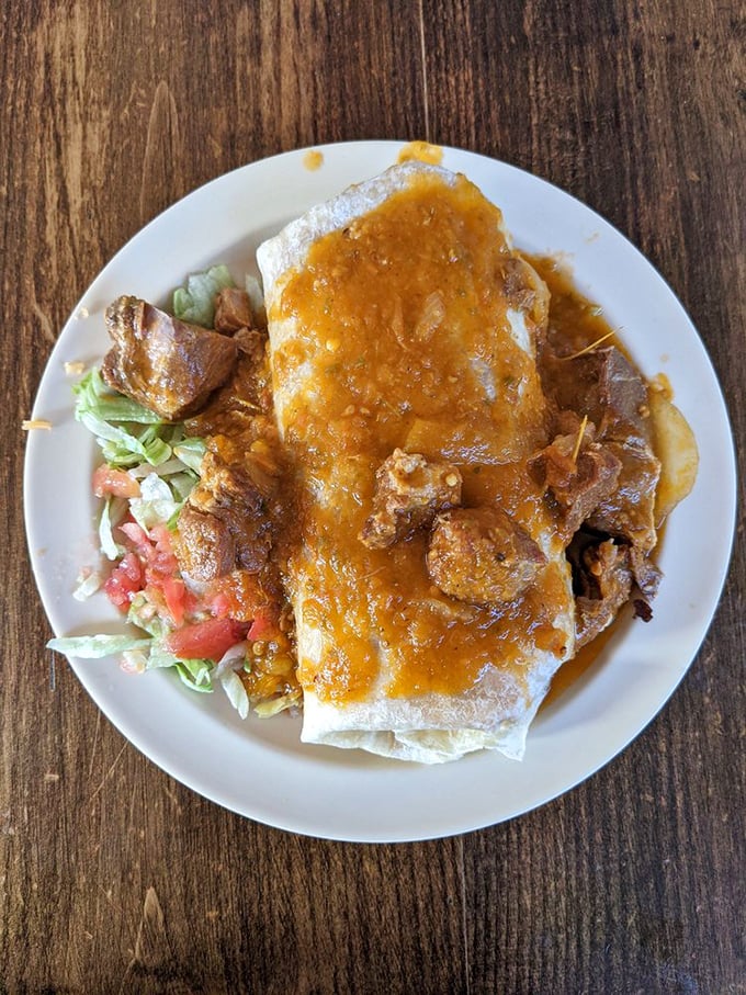This isn't just a burrito; it's edible architecture. The sauce cascade makes resistance futile—your shirt will eventually wear some as a badge of honor.
