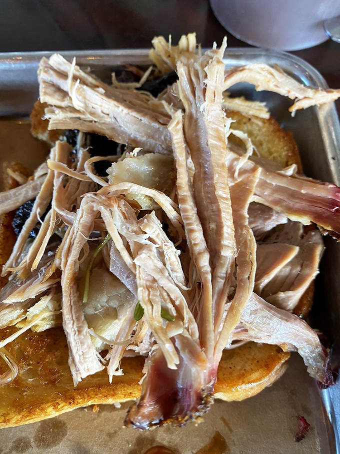 Pulled pork so tender, it practically falls apart when you look at it sideways – resistance is futile.