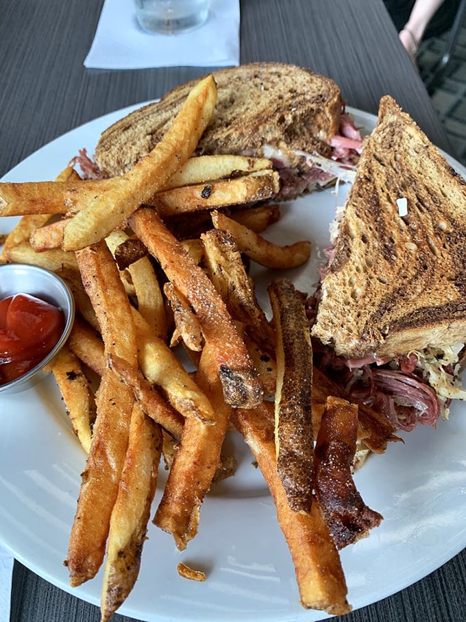 Behold the star of our show: a Reuben sandwich that doesn't just satisfy hunger—it creates memories. Those hand-cut fries aren't mere sidekicks; they're co-stars.