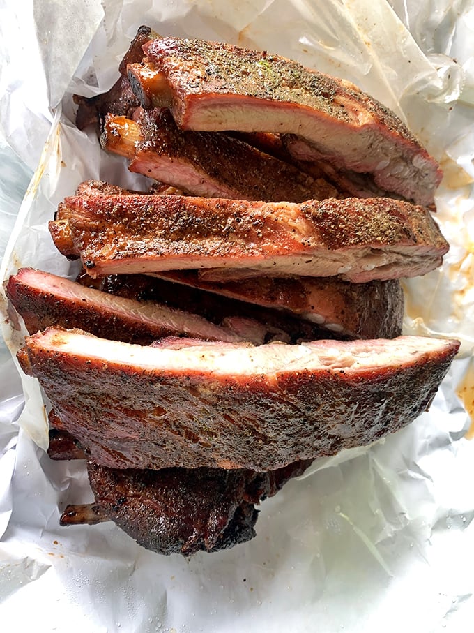 These ribs don't just fall off the bone—they practically leap into your mouth with that perfect pink smoke ring.