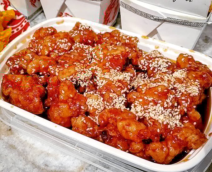 Sesame chicken glistening with that perfect sweet-savory glaze—the kind that makes you consider licking the serving spoon when nobody's looking.