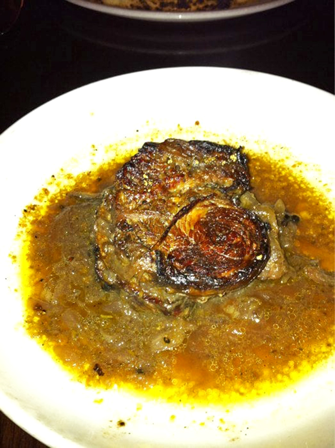 The short rib doesn't just fall off the bone—it practically leaps onto your fork, swimming in a sauce you'll want to bottle and take home.