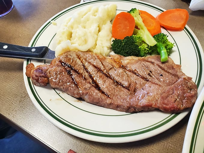 Behold the steak that launched a thousand return visits. Those grill marks aren't just decoration—they're flavor tattoos telling stories of perfect temperature control.