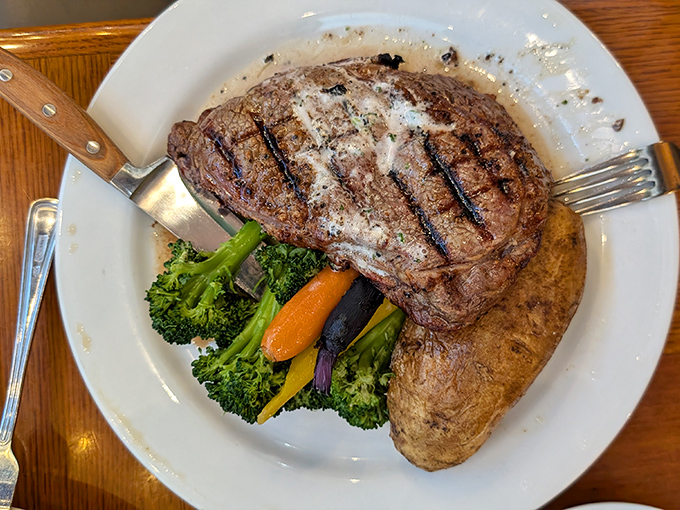 Not all heroes wear capes—some wear perfect grill marks. This steak, accompanied by its colorful vegetable entourage, is ready for its close-up.