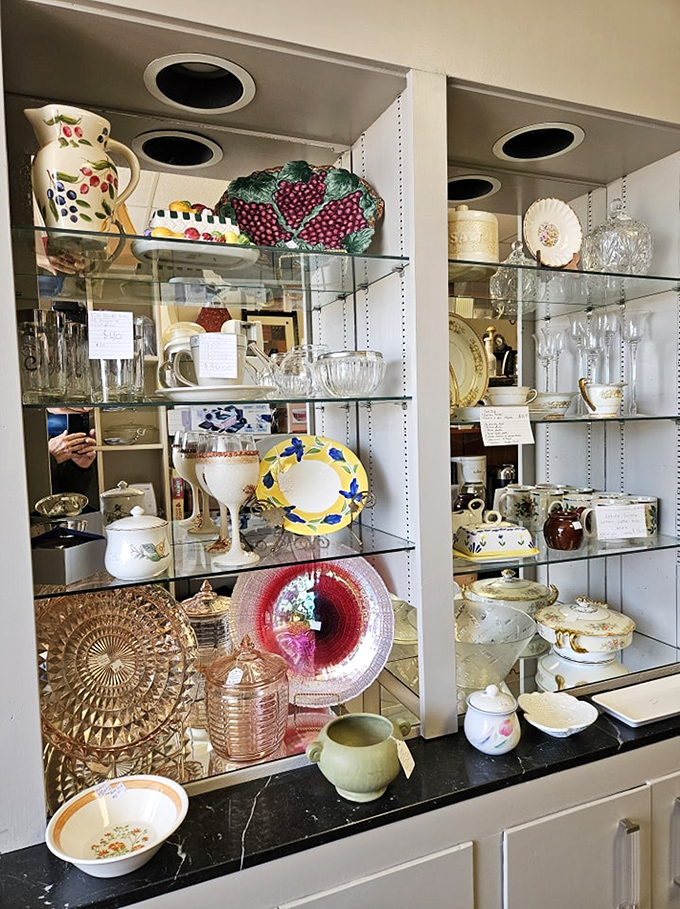 Glass shelves gleaming with forgotten elegance. That grape-patterned serving platter is just waiting to star at your next dinner party.
