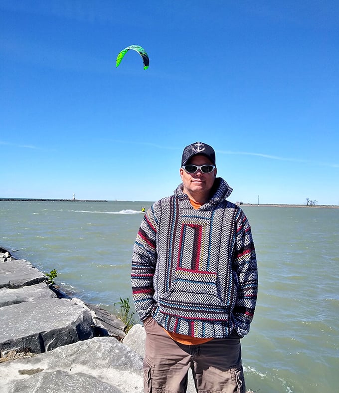 Lake Erie's rocky breakwall offers the perfect vantage point for watching kiteboarders. The poncho sweater says "I'm prepared for lake weather" in the most stylish way possible.
