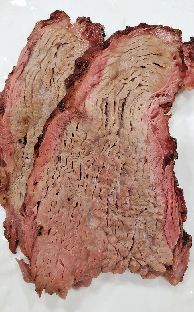 This tri-tip's perfect pink center and textured grain tells you everything—someone in that kitchen understands the sacred art of smoking beef.
