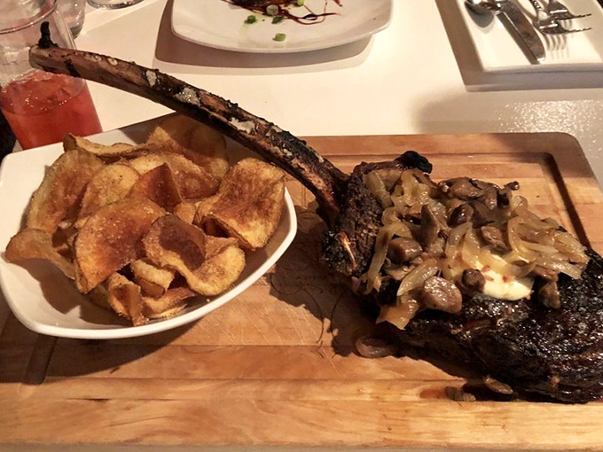 This isn't just steak—it's a meaty monument with house-made potato chips. That bone could double as a caveman's club in a Flintstones episode.