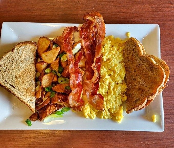 Breakfast perfection doesn't need fancy words – just eggs cooked exactly right, crispy bacon, and toast that's somehow better than the toast you make at home.